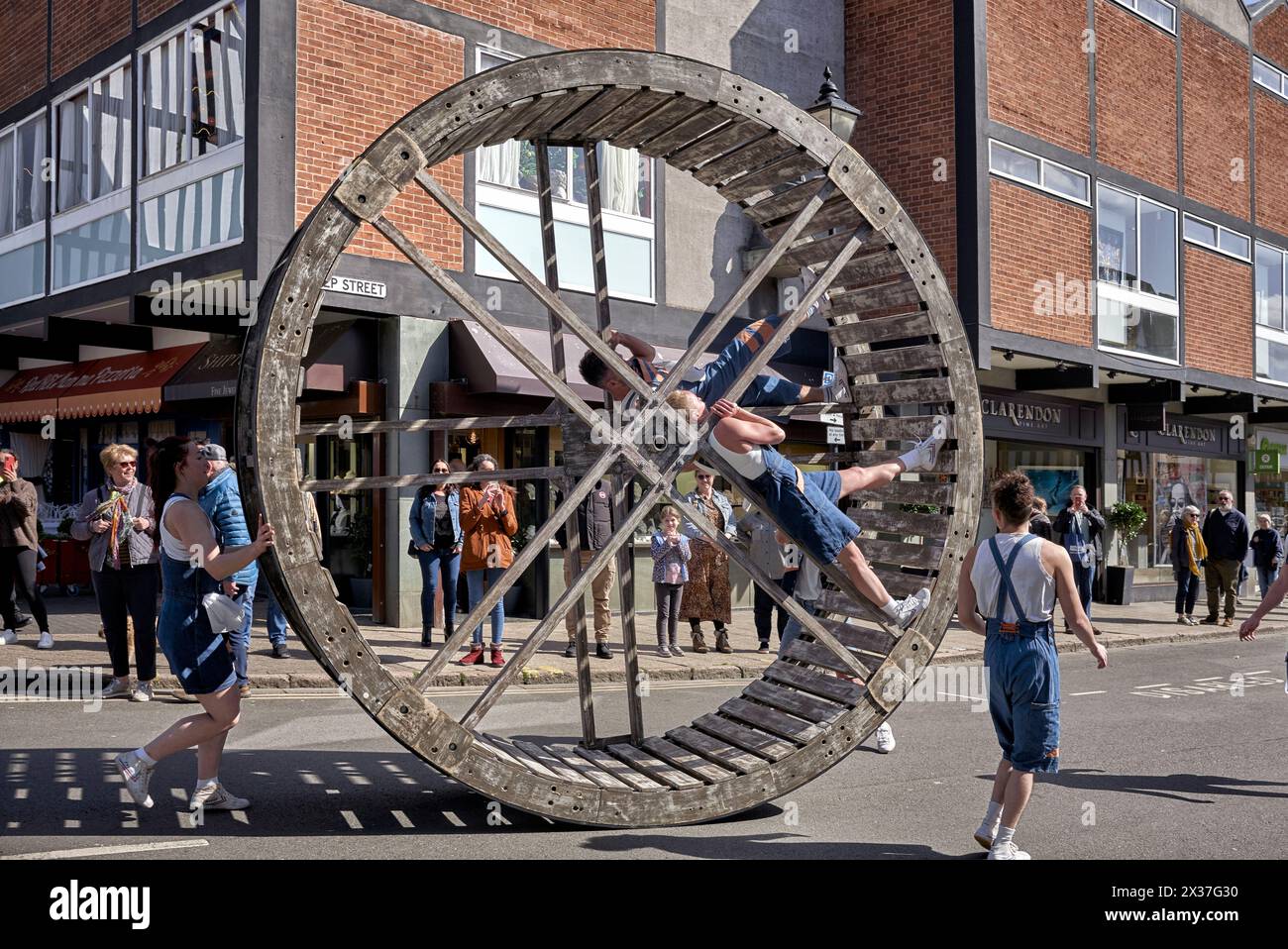 Shakespeare celebration parade with acrobats rolling a large wooden ...