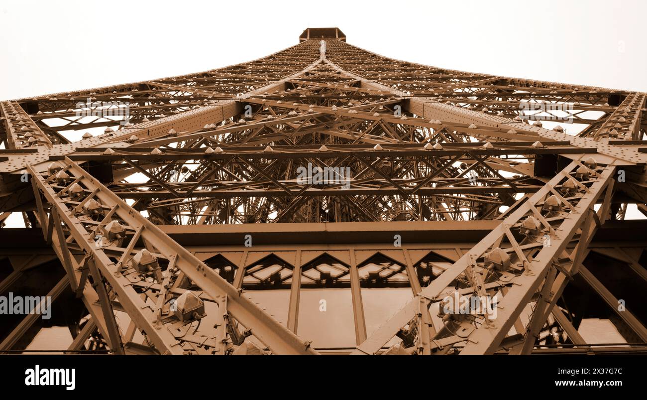 Looking up one side of the Eiffel Tower from and extreme angle showing the lines and curves of ...