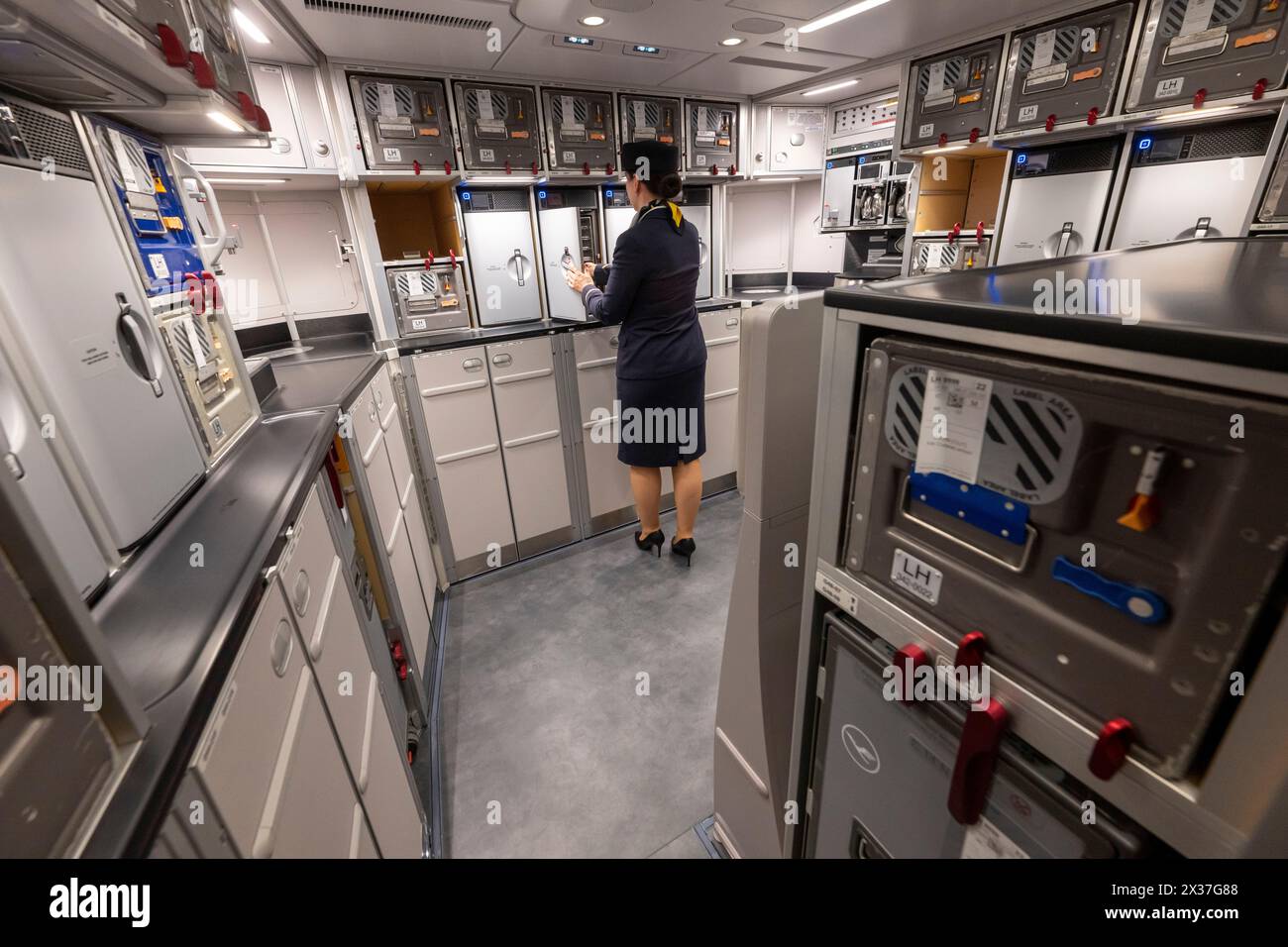 Munich, Germany. 25th Apr, 2024. A Lufthansa cabin crew member stands ...