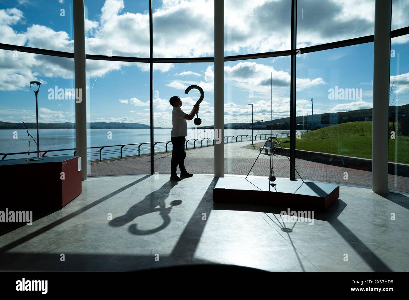 Gallery designer Andy McGregor with 'Question Mark (2005)' during a ...