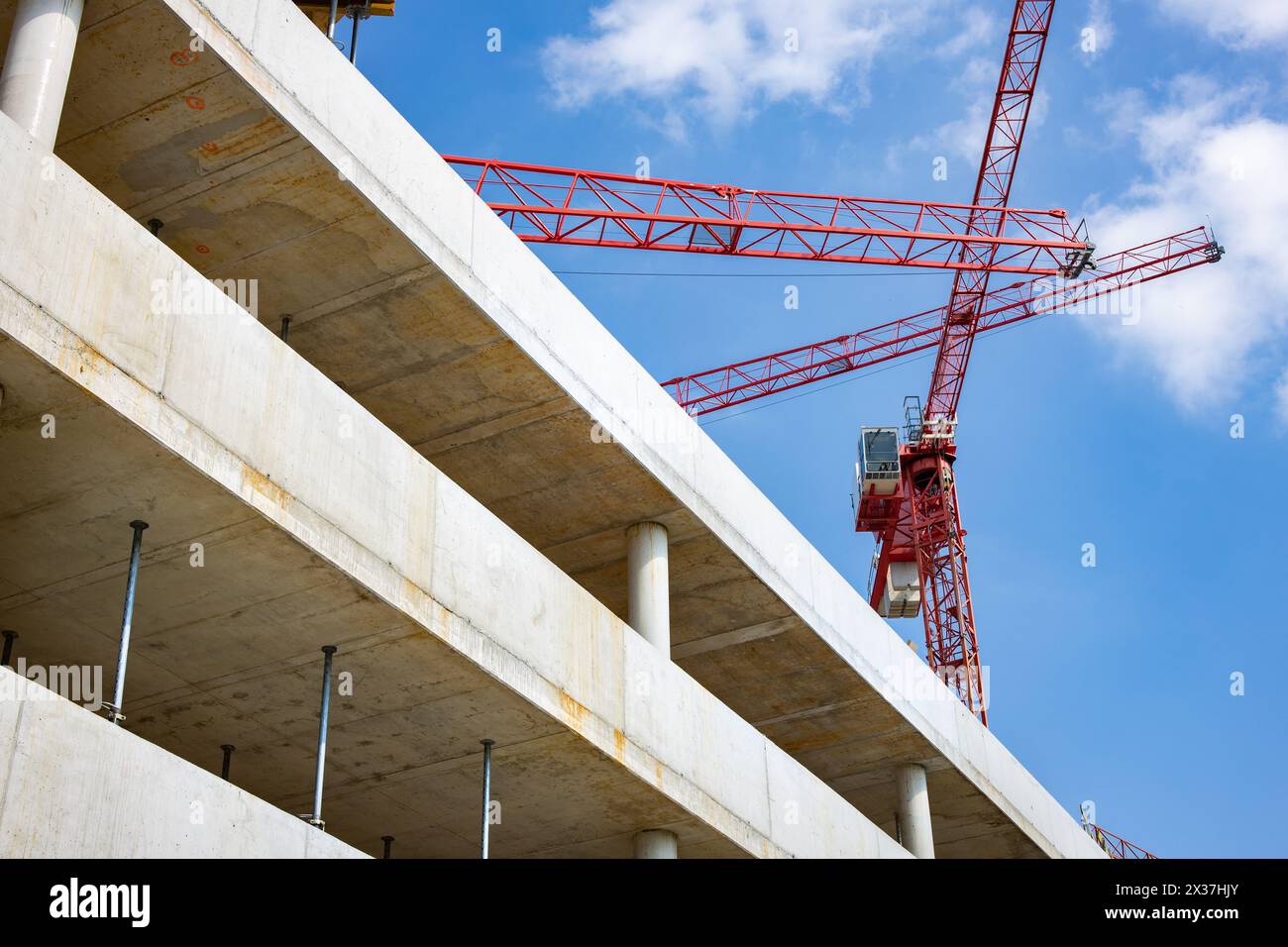 A construction site with a building shell in concrete and cranes ...