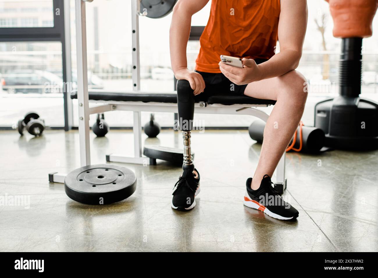 Determined athlete with a prosthetic leg resting during an inspiring ...