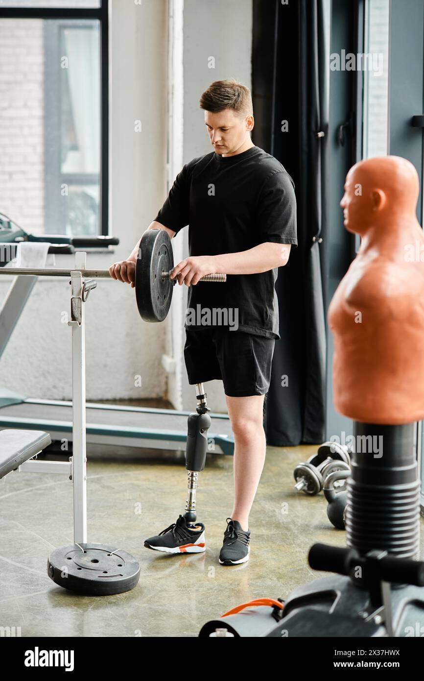 A disabled man with a prosthetic leg stands next to a sports machine in ...