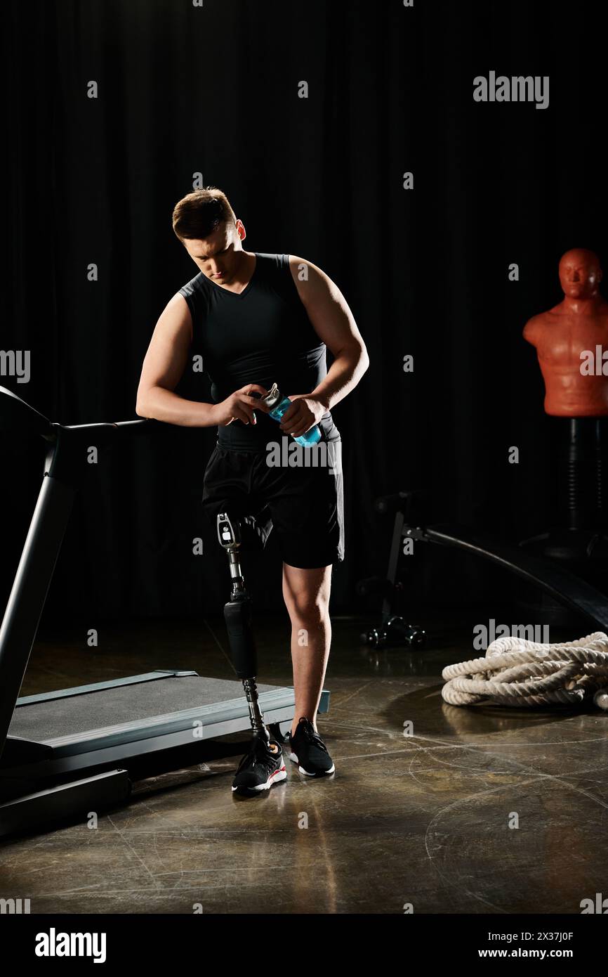 A man, sporting a prosthetic leg, stands on a treadmill in a dimly lit ...