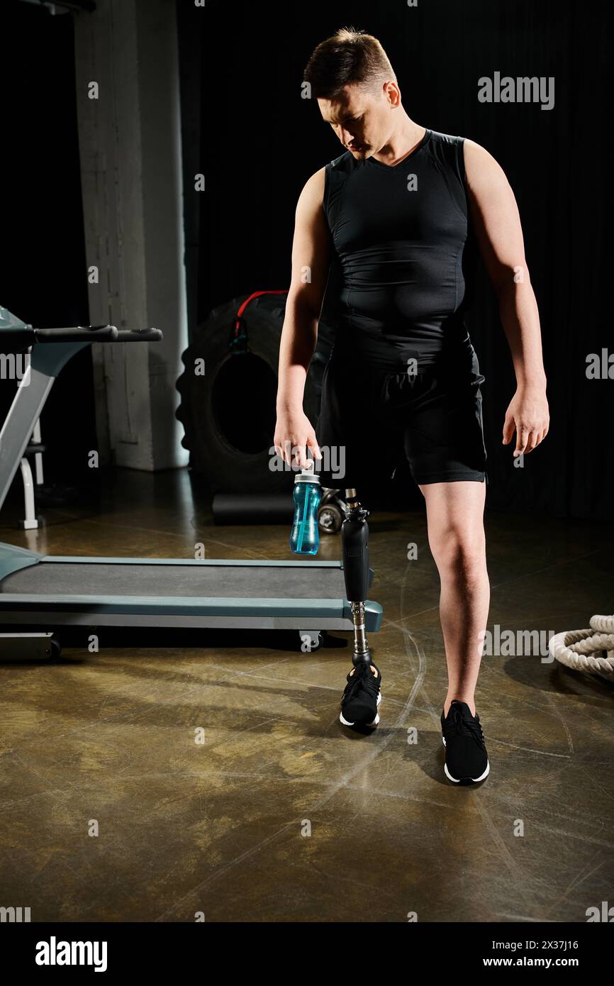 A man with a prosthetic leg stands next to a machine, focusing on his ...