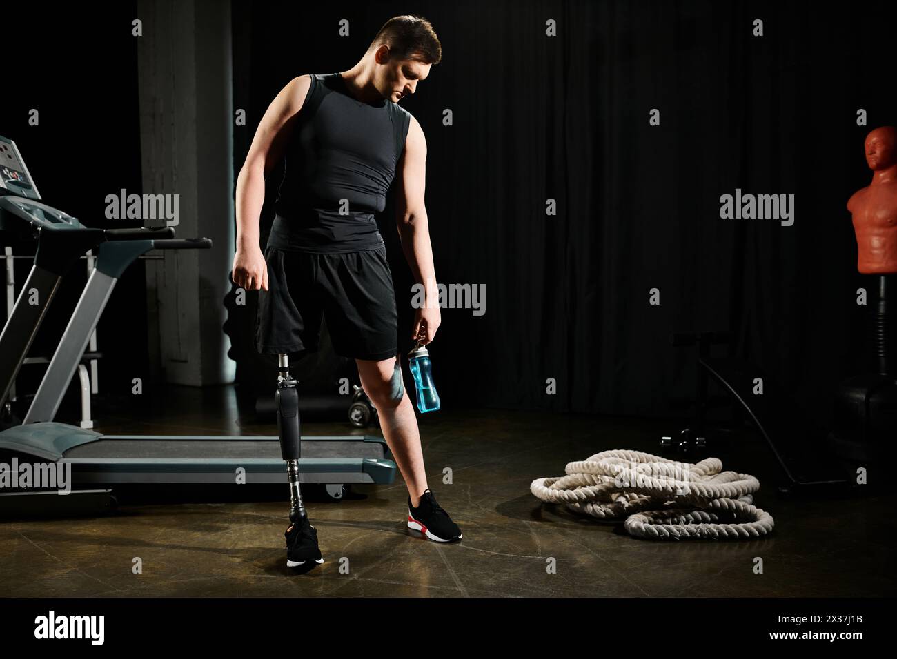 A man with a prosthetic leg stands beside a intricate machine in a ...