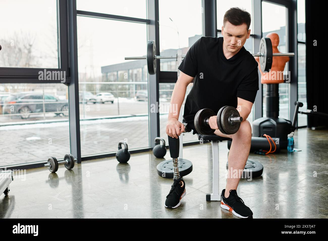 A determined man with a prosthetic leg exercises with a barbell in a ...