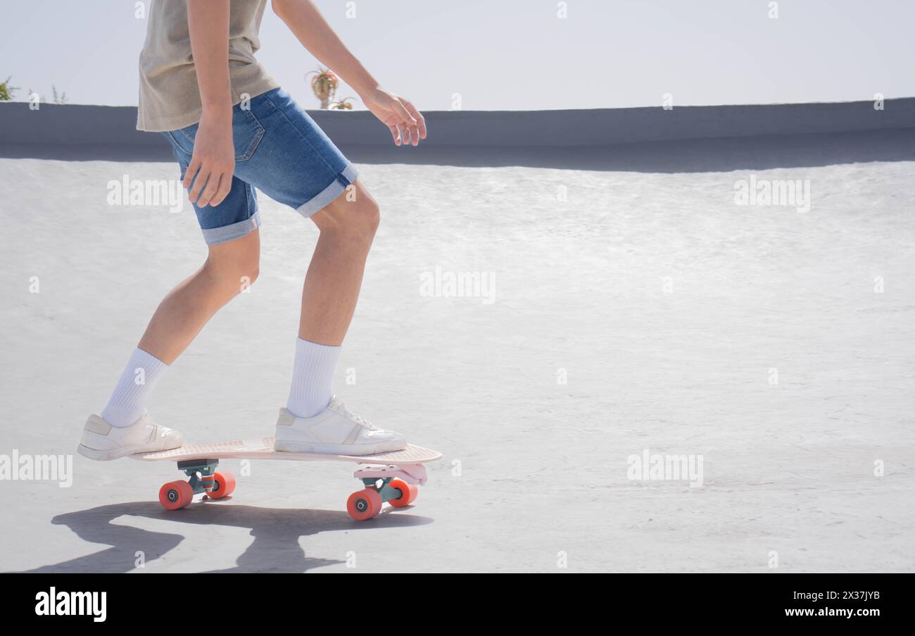 A young man is skillfully skateboarding on a ramp with a surfskate ...