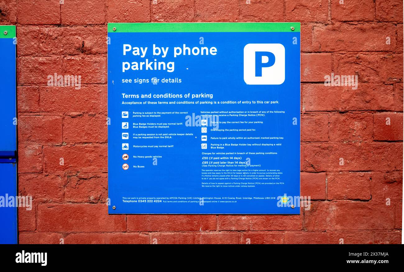 A blue and green sign indicating pay by phone for parking, London, UK ...