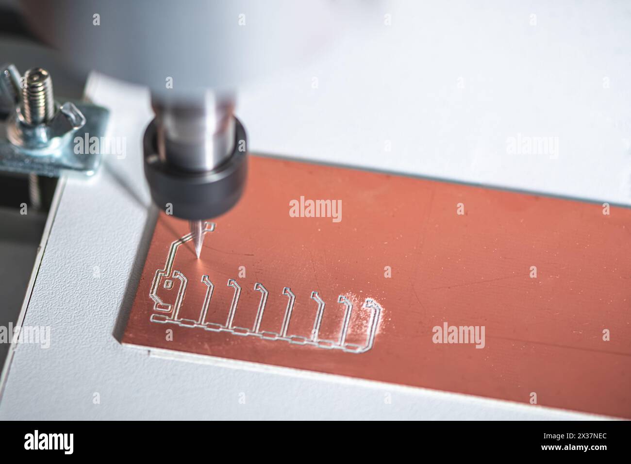 machine with numerical control CNC carries out milling of printed ...