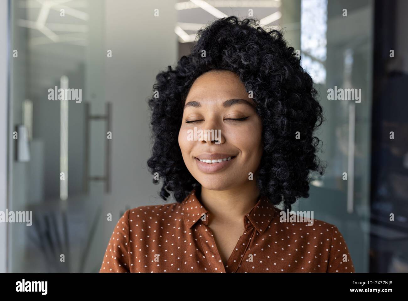 A portrait of a serene young woman enjoying a peaceful moment with ...
