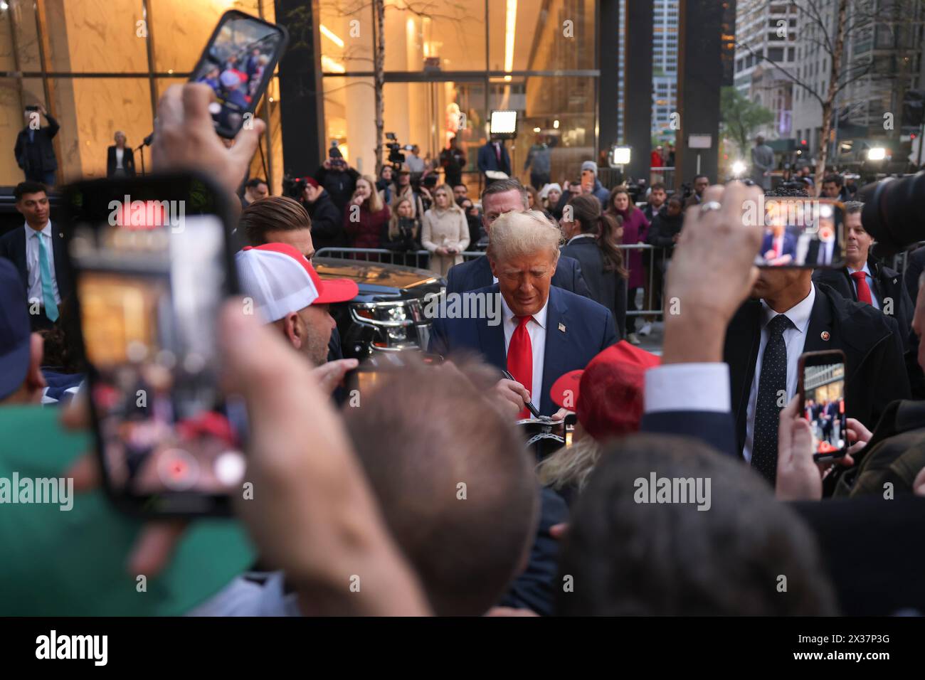 Former President Donald Trump signs autographs while speaking with ...