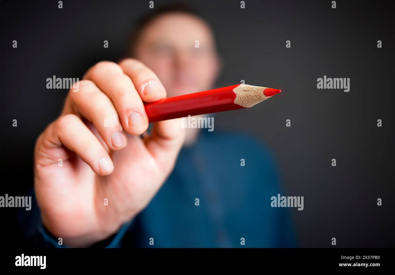 Tip of red pencil points at the camera and at you. Voting pencil with a ...