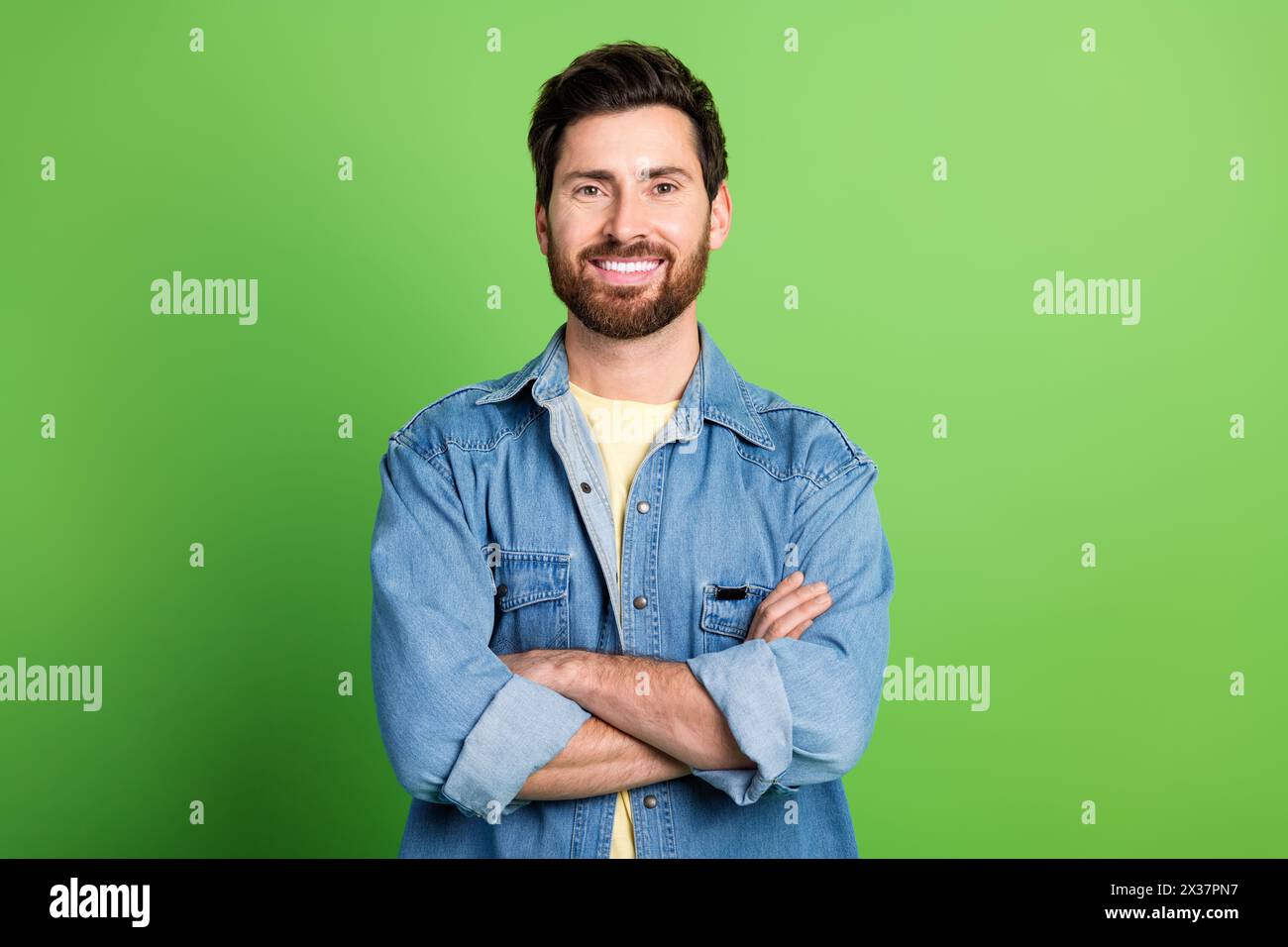 Photo of cheerful positive guy wear denim jacket arms folded smiling ...