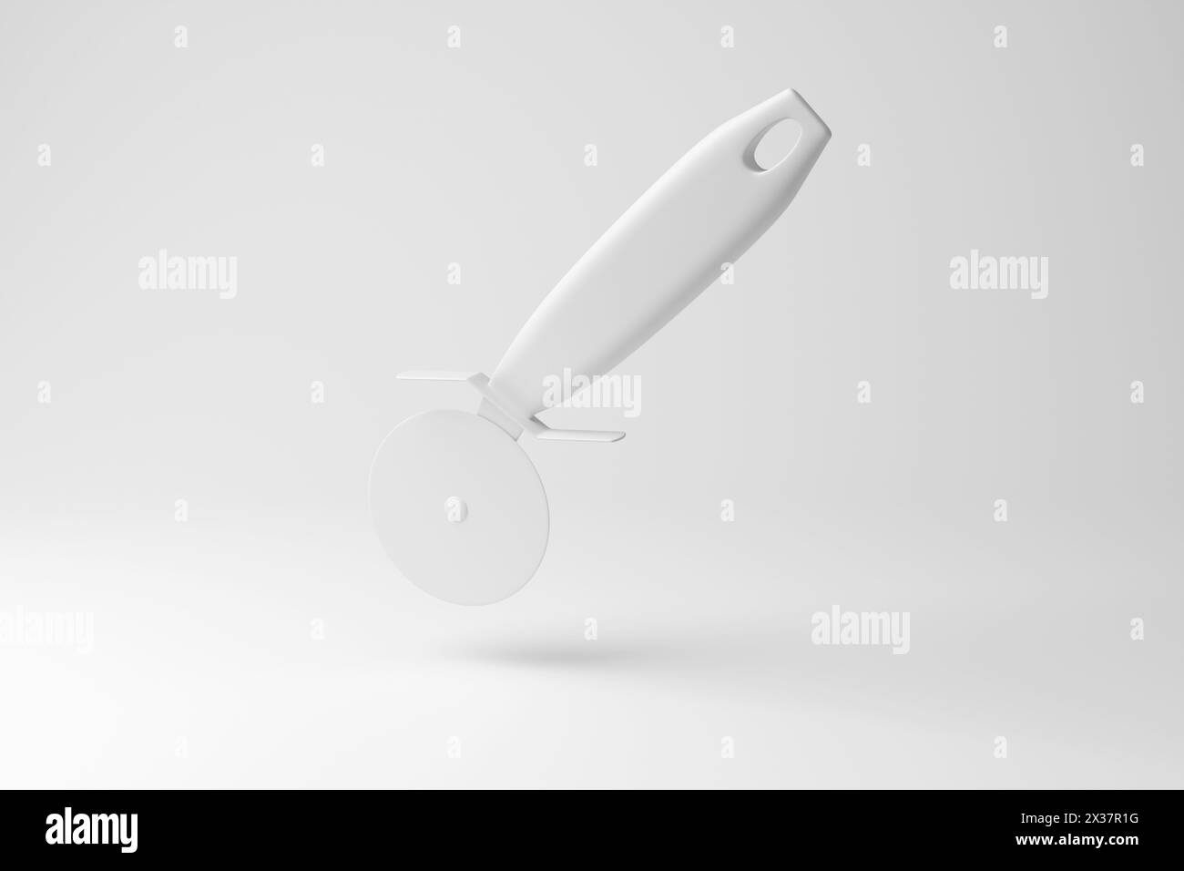 White pizza cutter floating in mid air on white background in ...