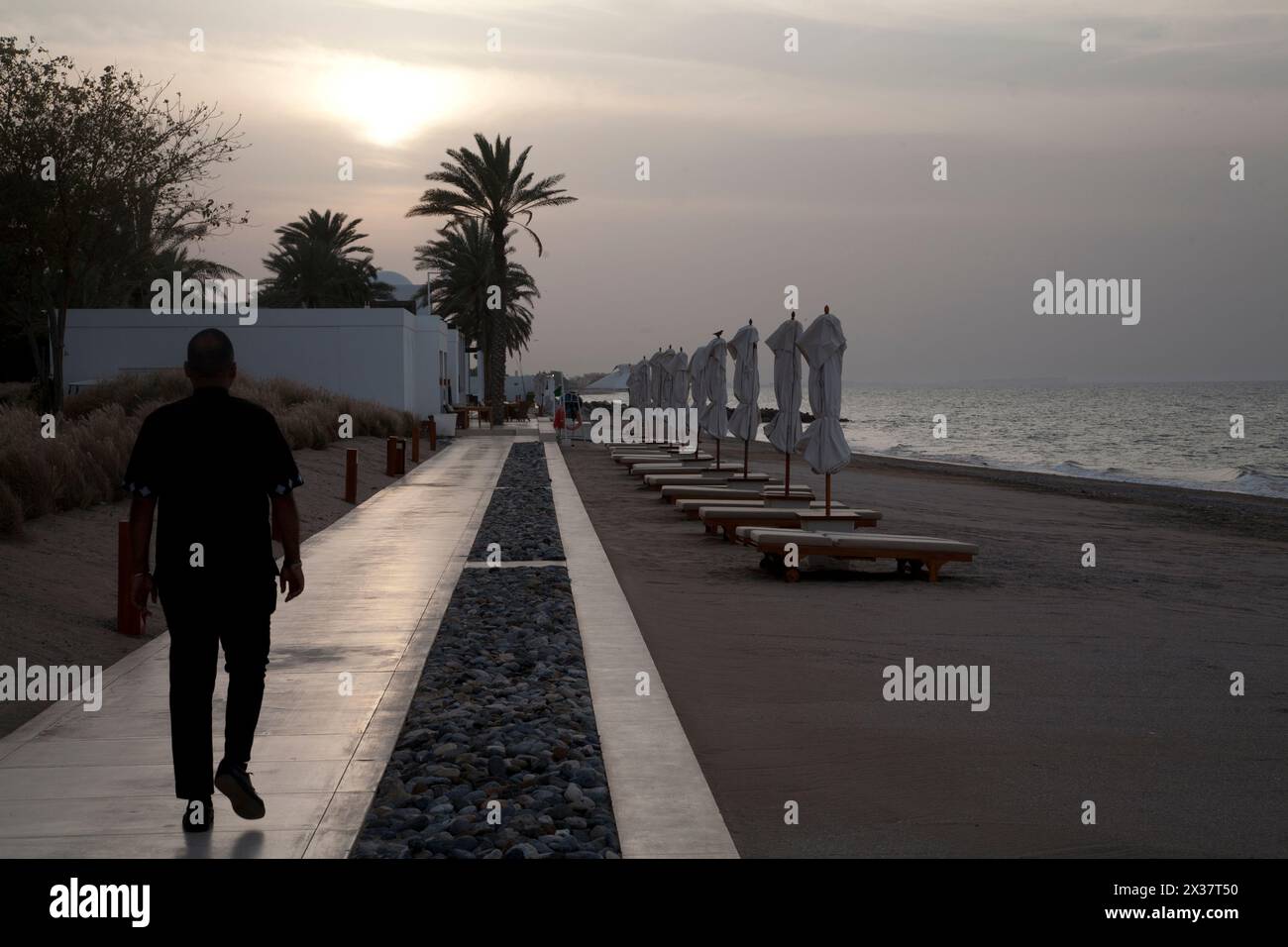 man on walkway by sea of oman the chedi hotel muscat oman middle east ...