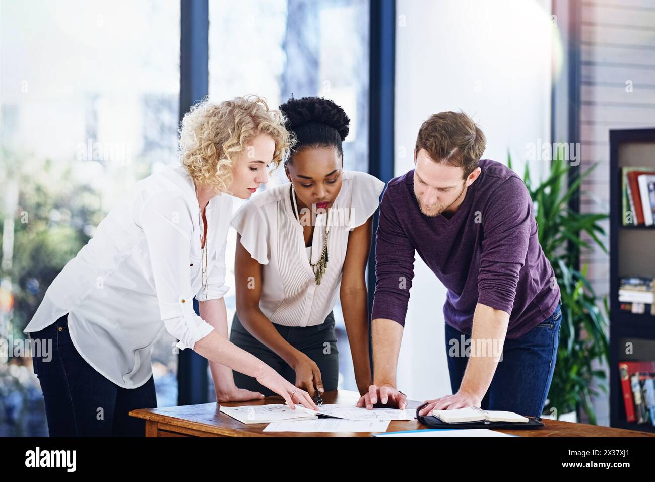 Business people, planning and teamwork with book publishing, brainstorming and reading or ...