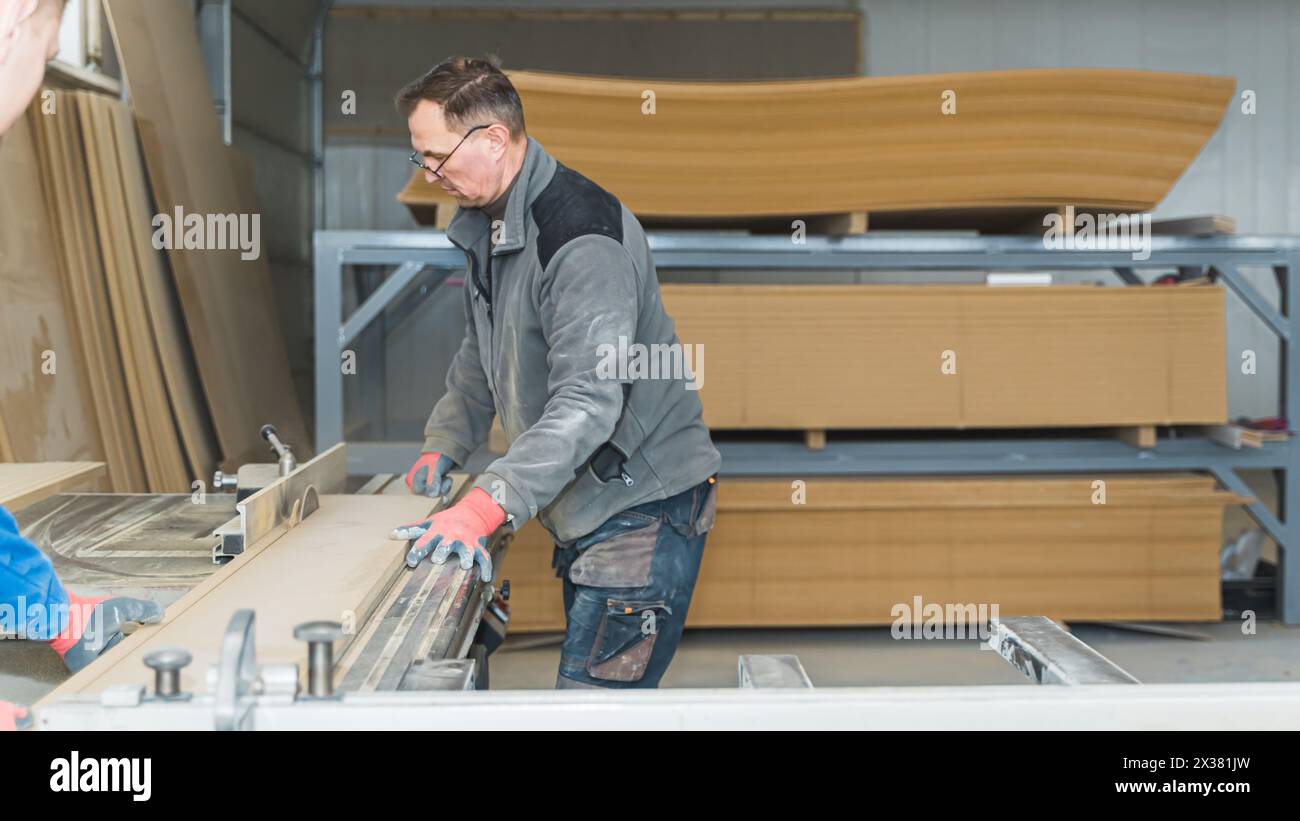 Senior male carpenter with glasses working at his workshop. High ...