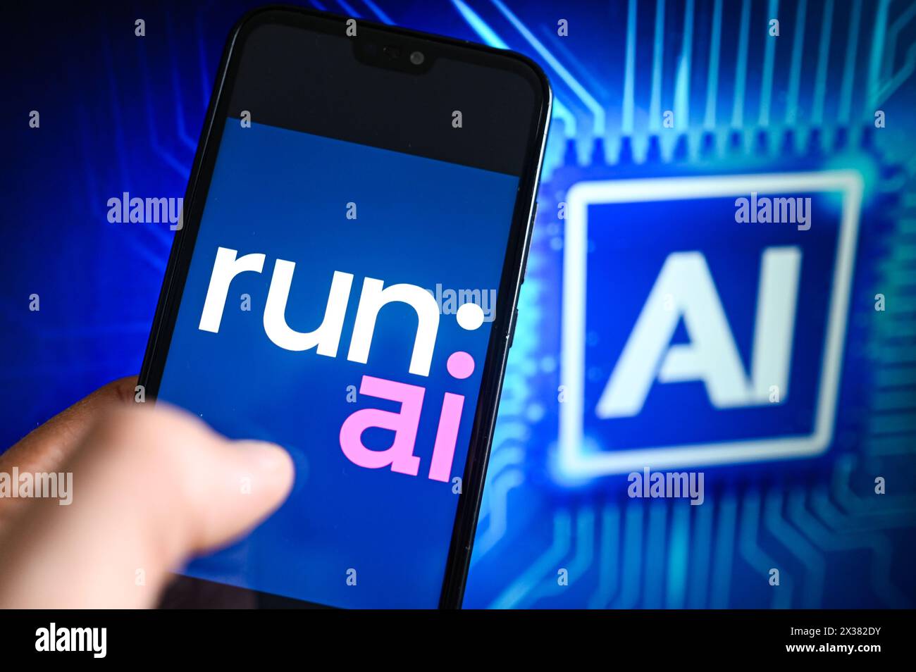 In this photo illustration the Run:ai logo is displayed on a smartphone with Artificial ...