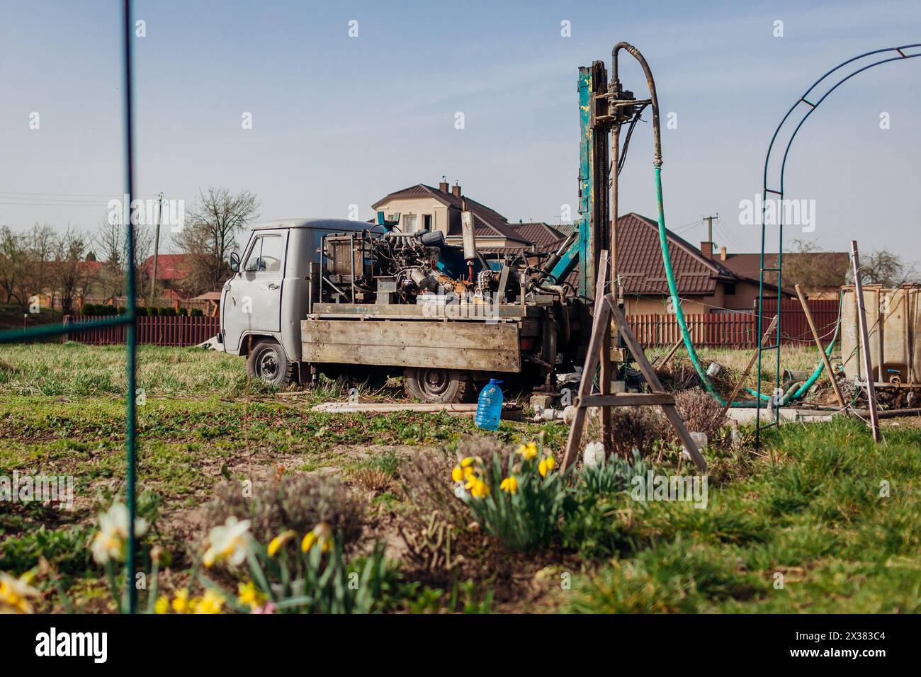 Drilling machine digging water hole in ground for well installation ...