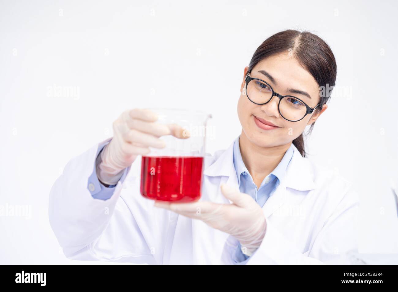The female scientist is conducting an experiment in the laboratory ...