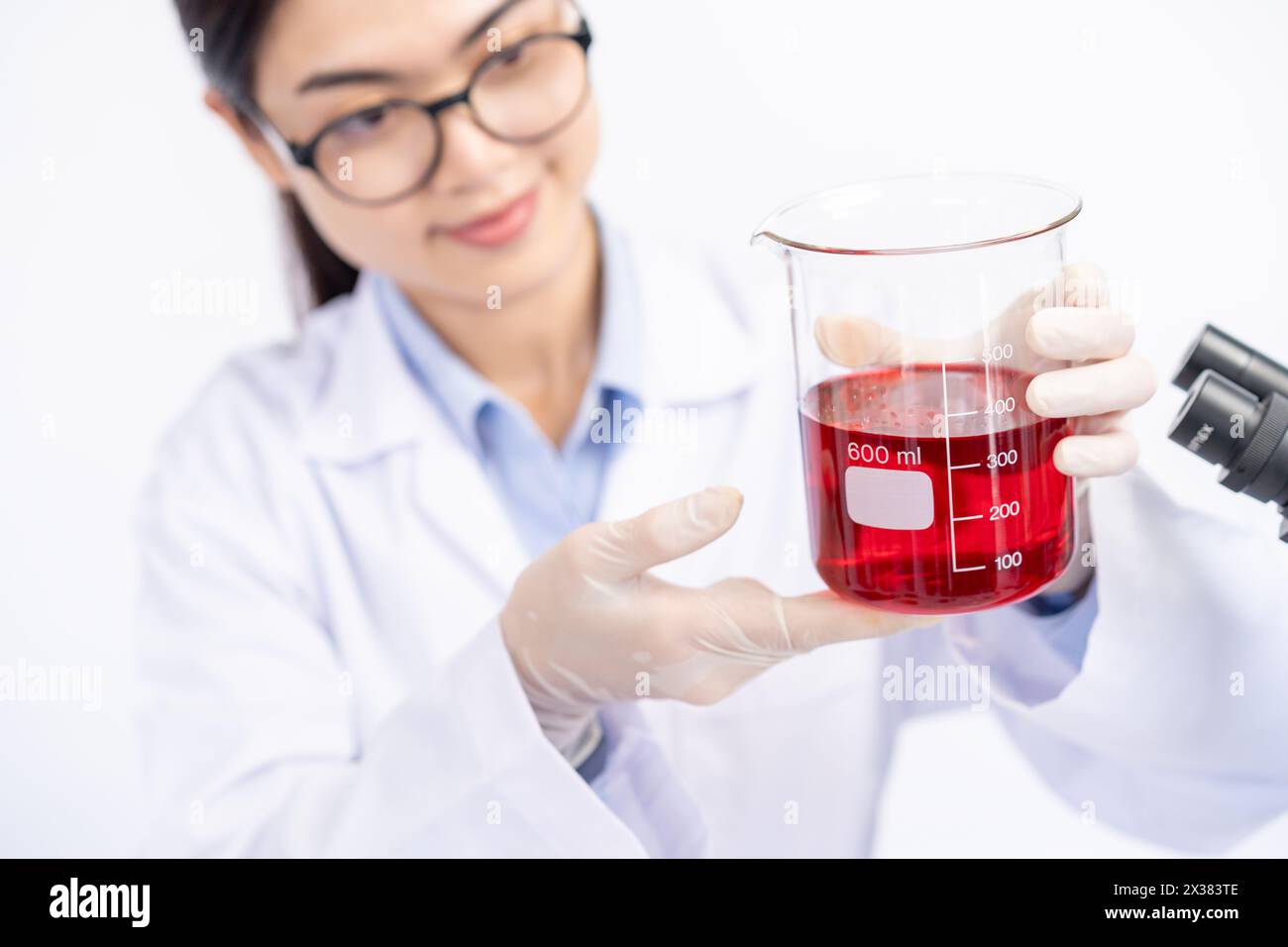 The female scientist is conducting an experiment in the laboratory ...