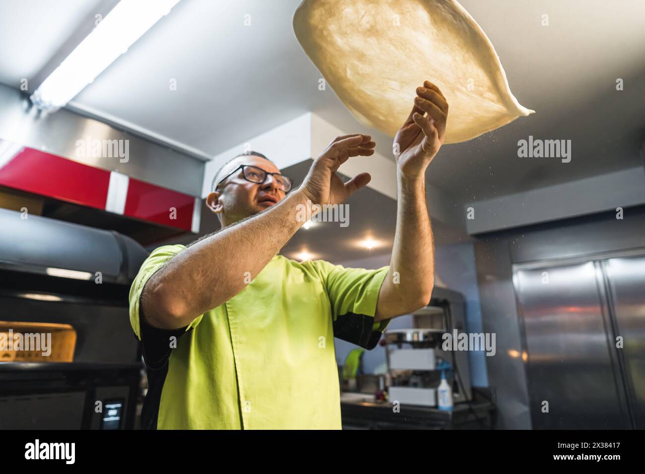 Pizza maker spinning dough in kitchen. High quality photo Stock Photo ...