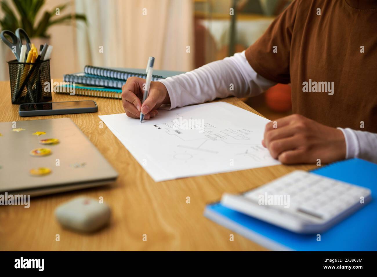 Talented school student drawing wireframe of his future application ...