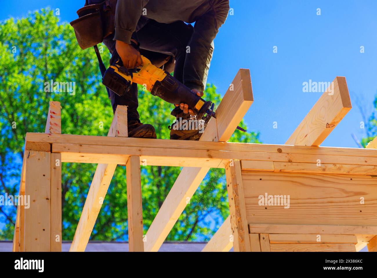 Reciprocating saw is used to cut wood beams in construction theme Stock ...