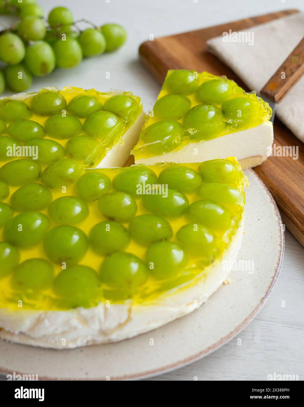 Cheesecake with grapes on a sponge cake base Stock Photo - Alamy