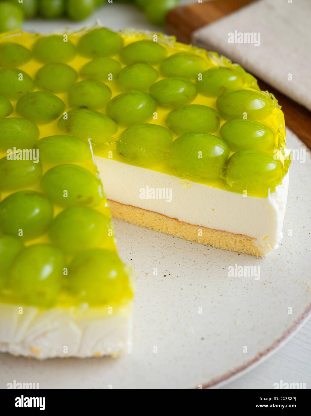 Cheesecake with grapes on a sponge cake base Stock Photo - Alamy