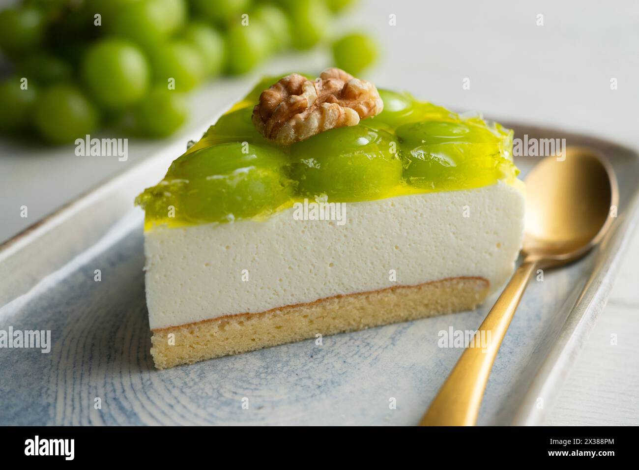 Cheesecake with grapes on a sponge cake base Stock Photo - Alamy