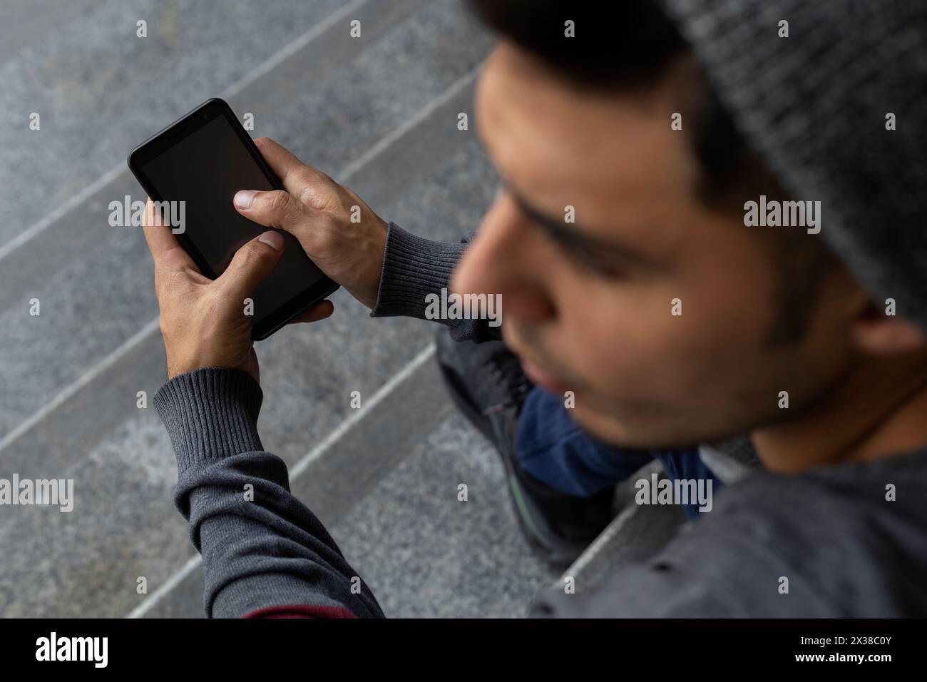 Out of focus profile of young male (22) Latin American sitting on the ...