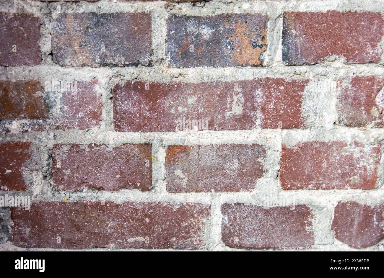Gray structural stone wall of the ancient building consists of old dark ...