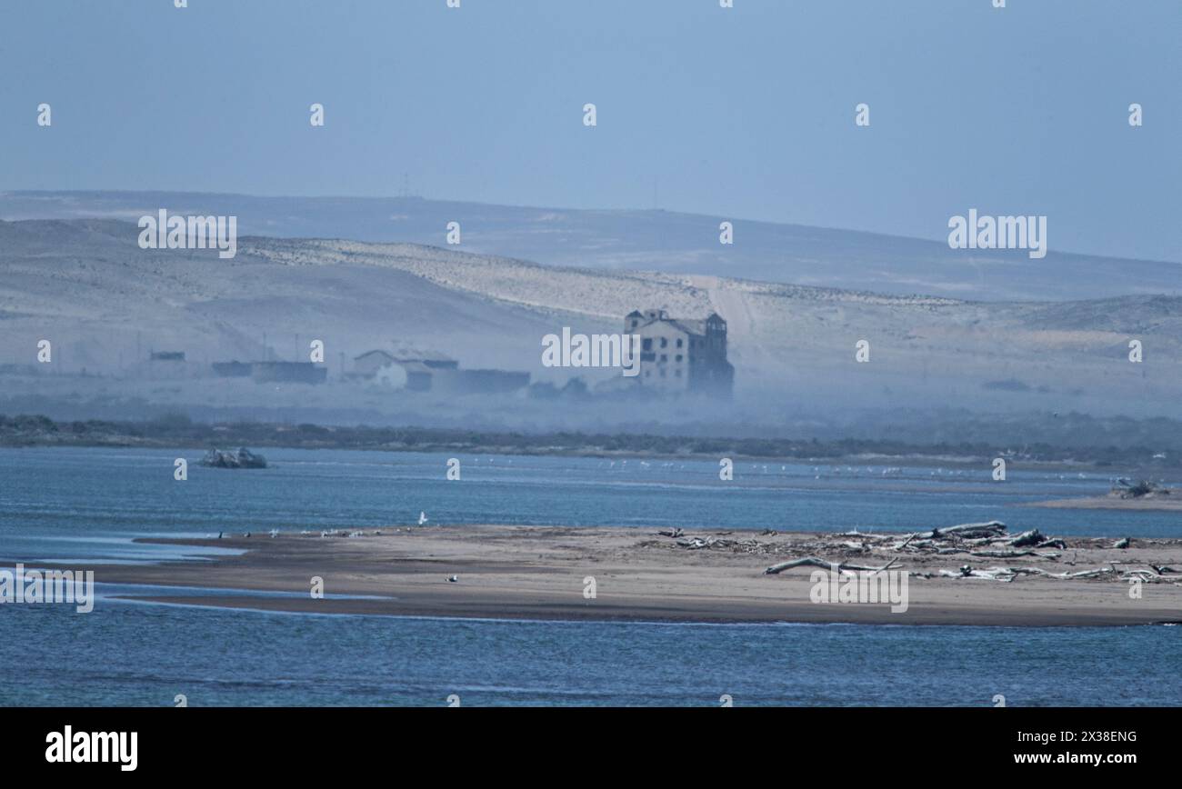 The mist clearing showing an exposed sand bar with driftwood and the ...