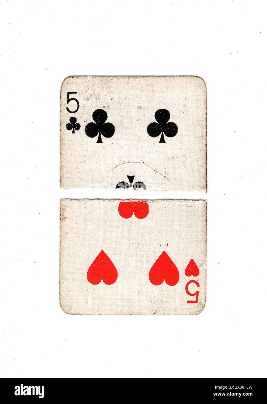 A vintage five playing card made up of different suits in torn halves ...