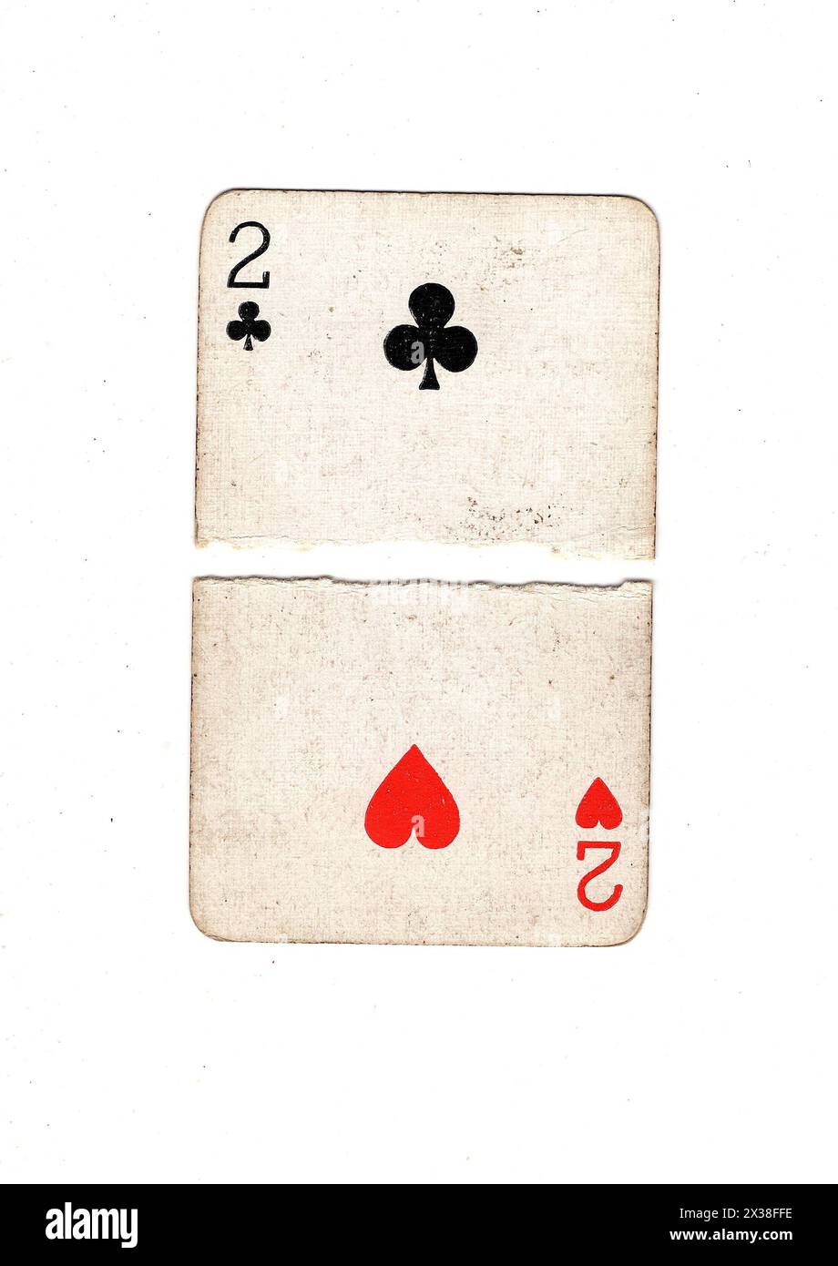 A vintage two playing card made up of different suits in torn halves ...