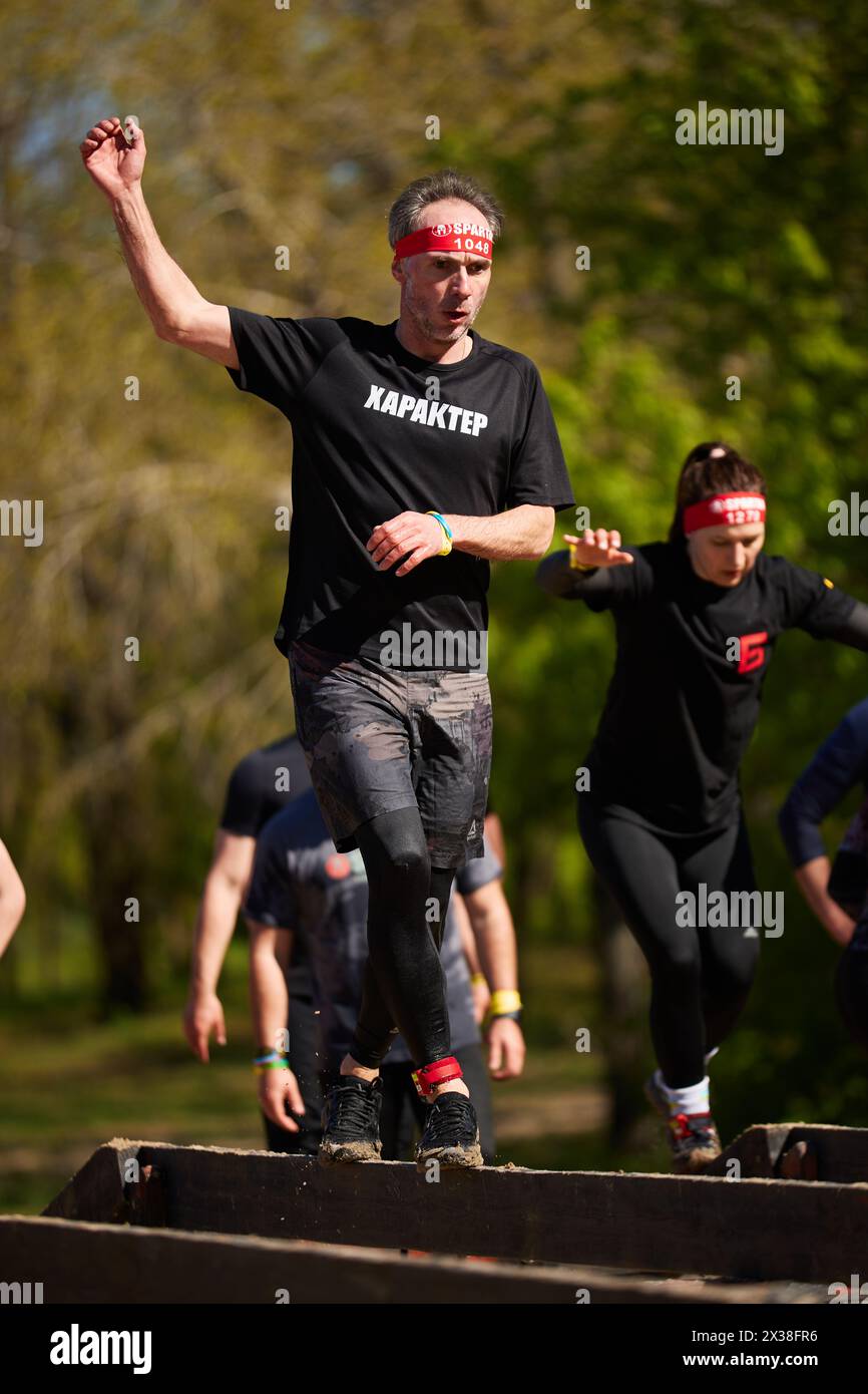 Athlete walks on balance beam at the Spartan Race competition in Kyiv ...