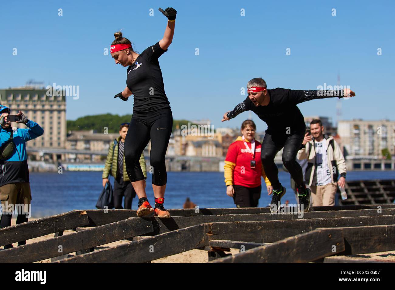 Athletes walking on a wooden plank. Balance beam discipline at the ...