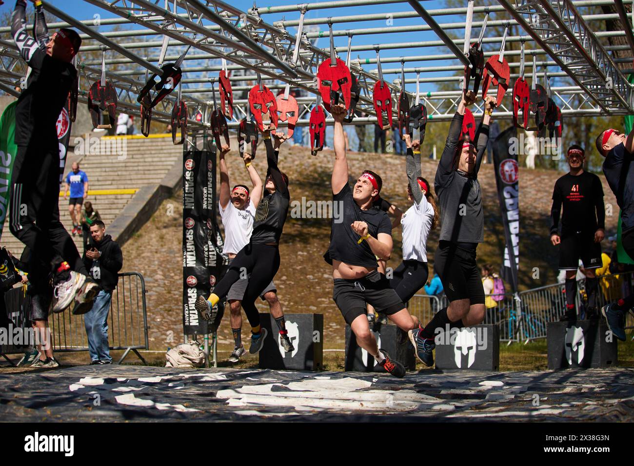 Group of athletes compete in swinging on a multi rig swing at the ...