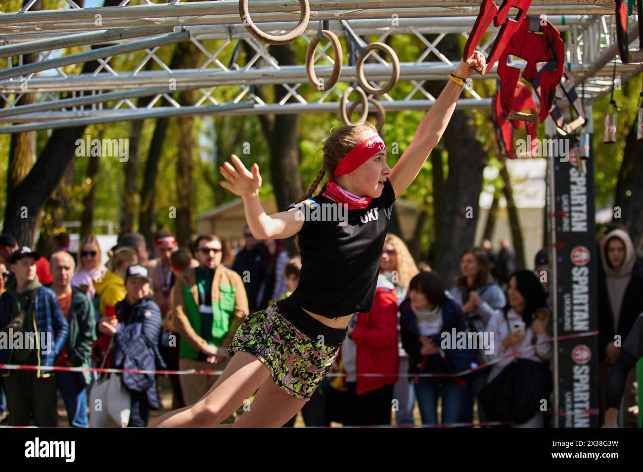 Young Ukrainian girl swinging on a multi rig at the Spartan Race ...