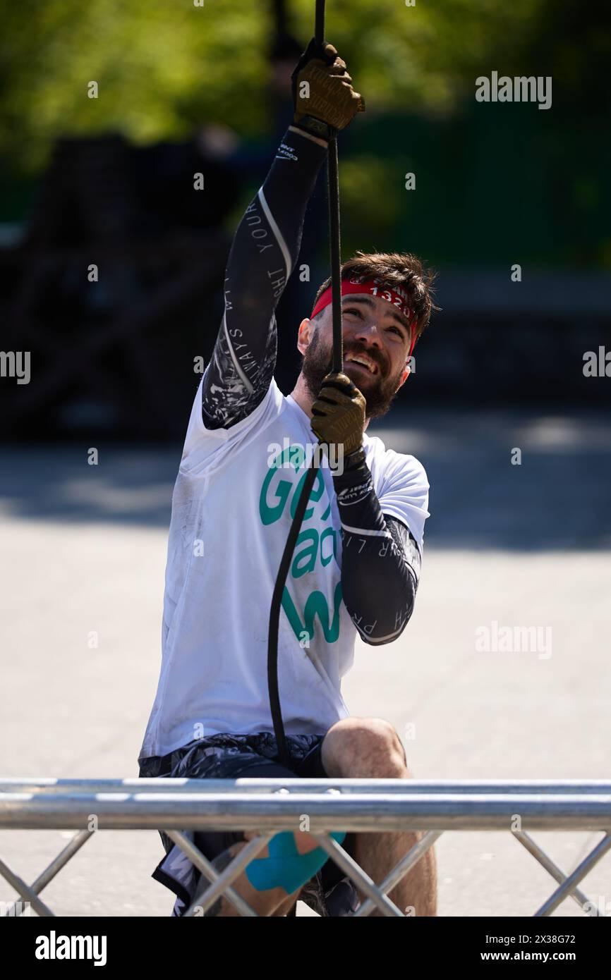 Slim young man weighting heavy weigh on a Hercules hoist at the Spartan ...