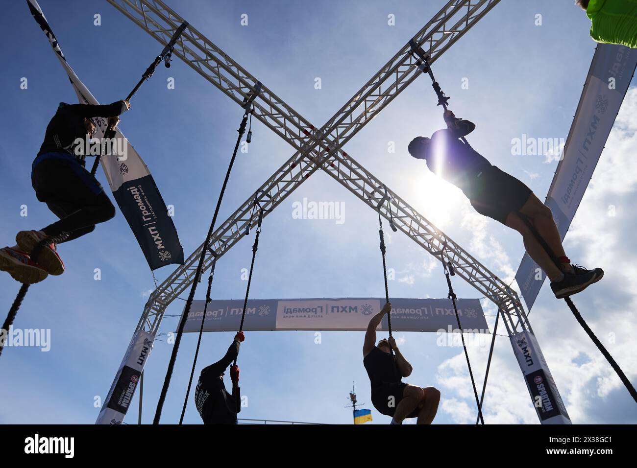 Athletes climbing the ropes at the Spartan Race competition in Kyiv ...