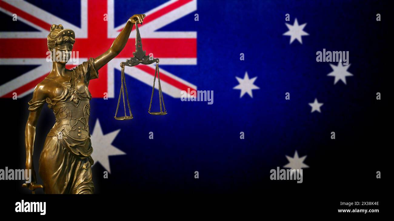 Close-up of a small bronze statuette of Lady Justice before a ...