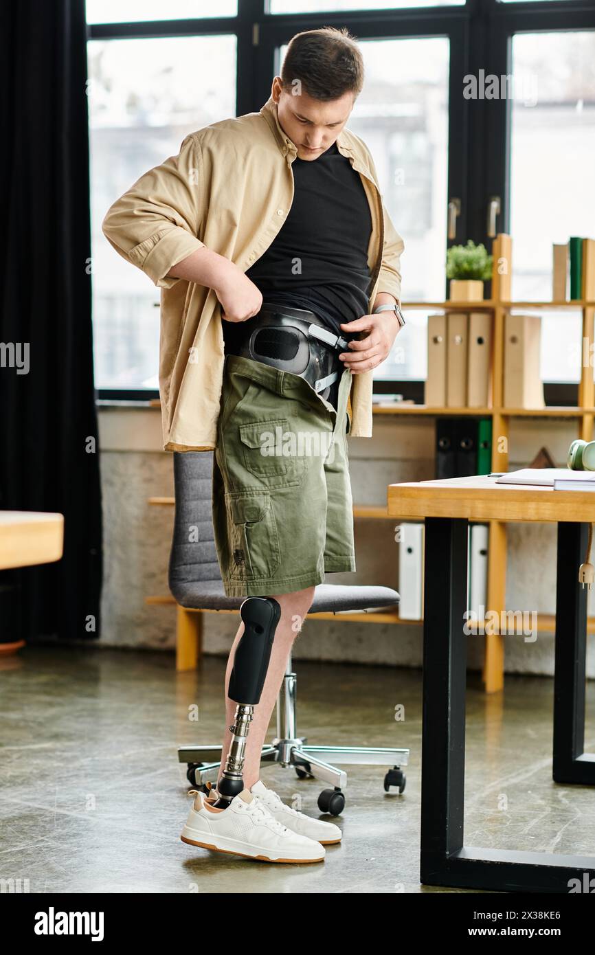 A man confidently balances on his prosthetic leg in a room Stock Photo ...