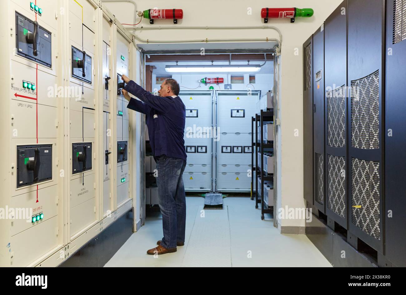 Maintenance worker, UPS, batteries for uninterrupted electricity ...
