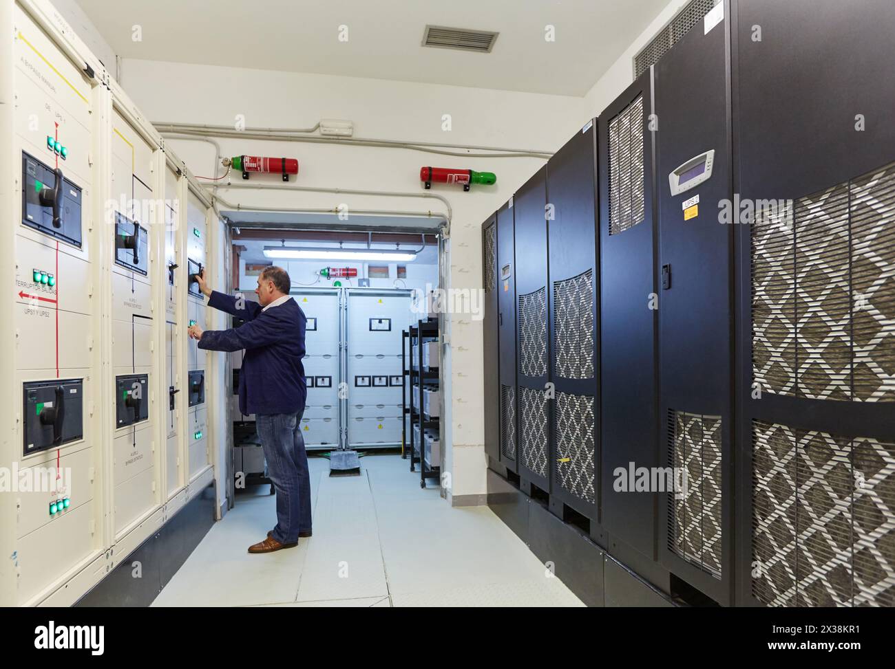 Maintenance worker, UPS, batteries for uninterrupted electricity ...