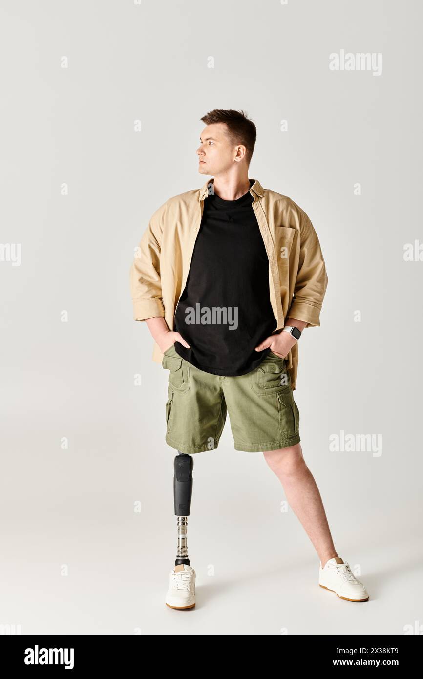 A handsome man with a prosthetic leg poses in an active and graceful ...