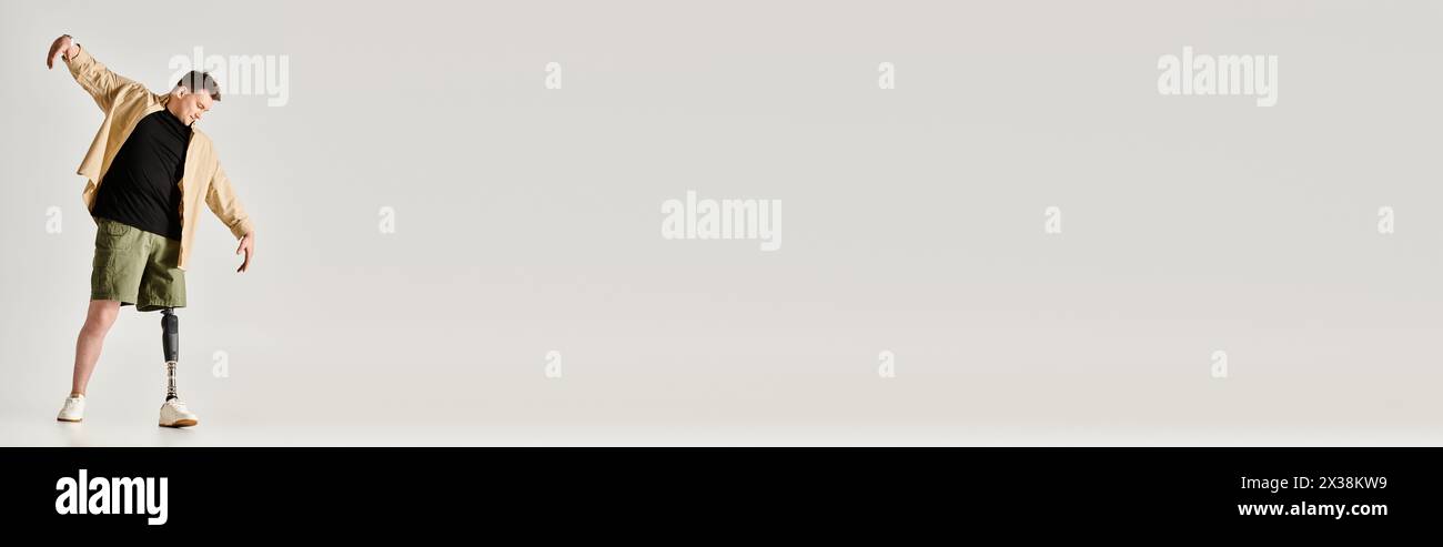 Handsome man with prosthetic leg in a cast, striking a dynamic pose ...