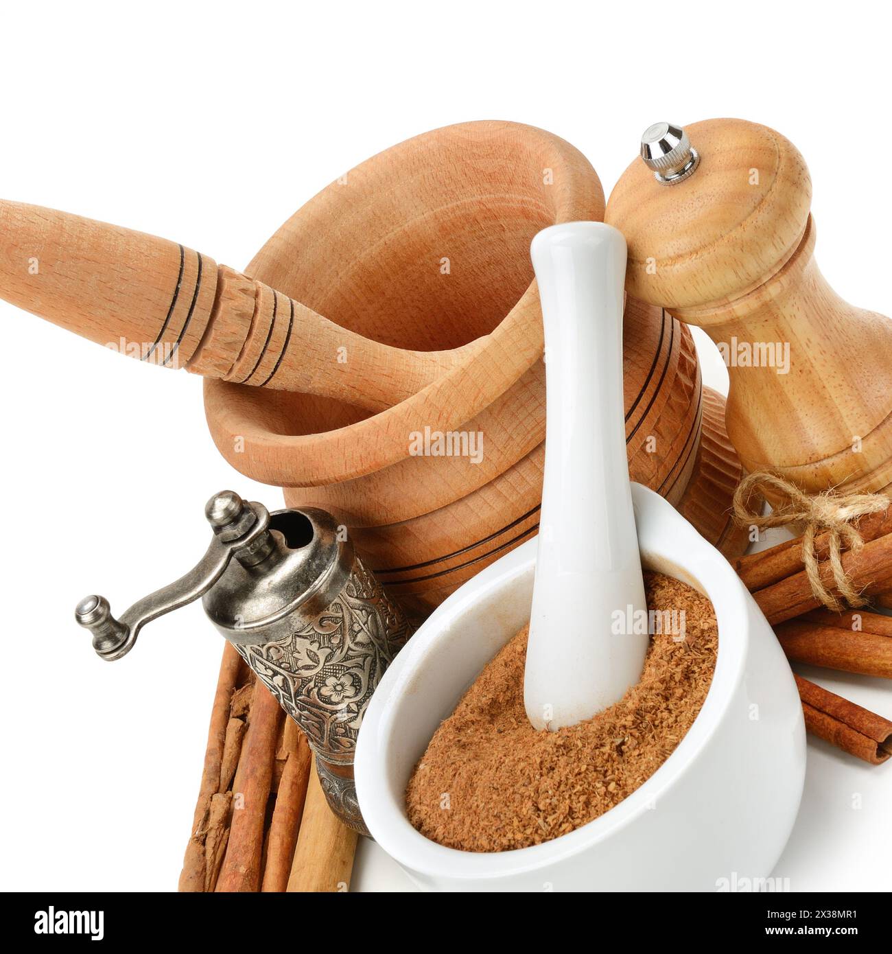 Sticks and cinnamon powder. Mortar, pestle and mill isolated on white ...